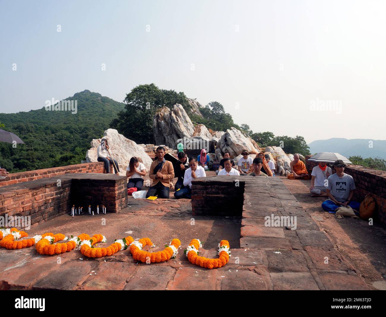 PILGRIMS AND A MONK MEDITATING AT VULTURES PEAK, RAJGIR, BIHAR, INDIA ...