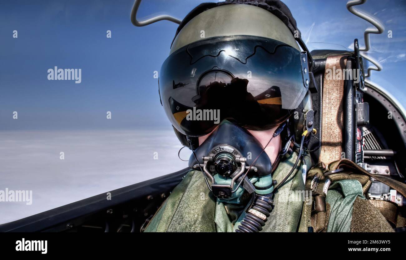 Fighter pilot in a jet flying high in the sky with visor, helmet and ...