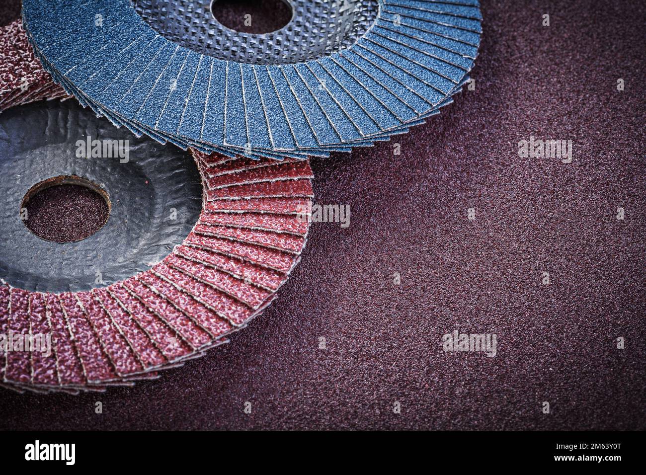 Abrasive flap wheels on sandpaper sheet top view Stock Photo - Alamy