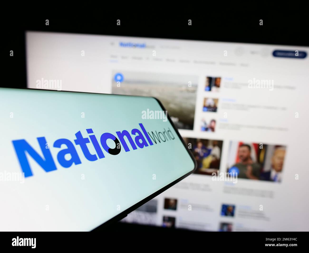 Cellphone with logo of British media company National World plc on ...