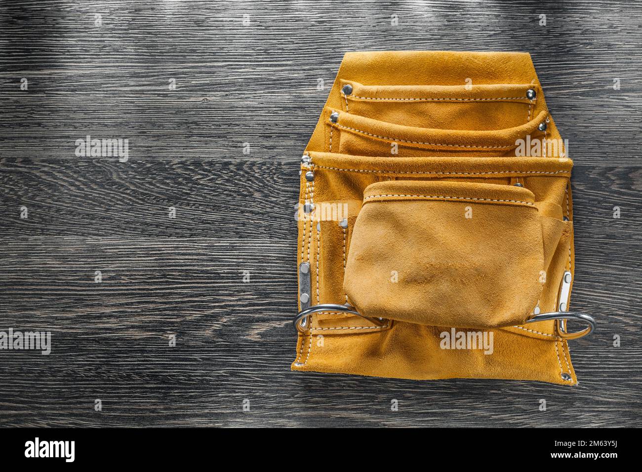 Building belt on wooden board top view Stock Photo - Alamy