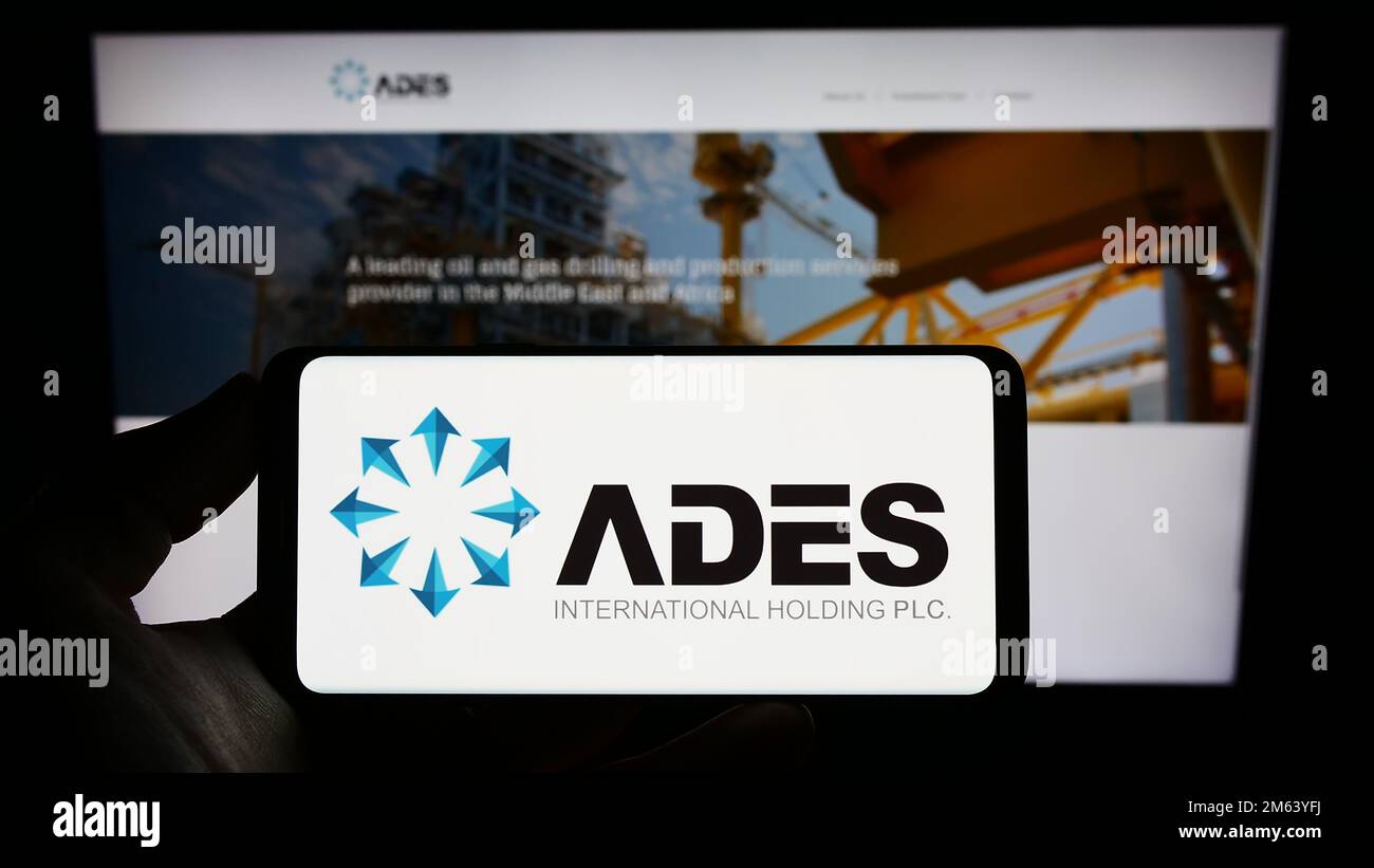 Person holding smartphone with logo of Egyptian company ADES ...