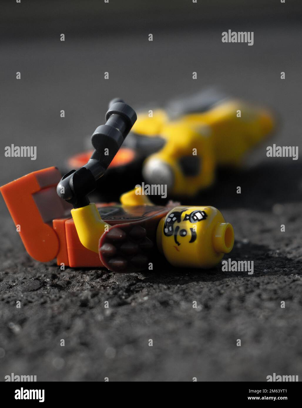 A Lego figure involved in a motorcycle crash in closeup Stock Photo - Alamy