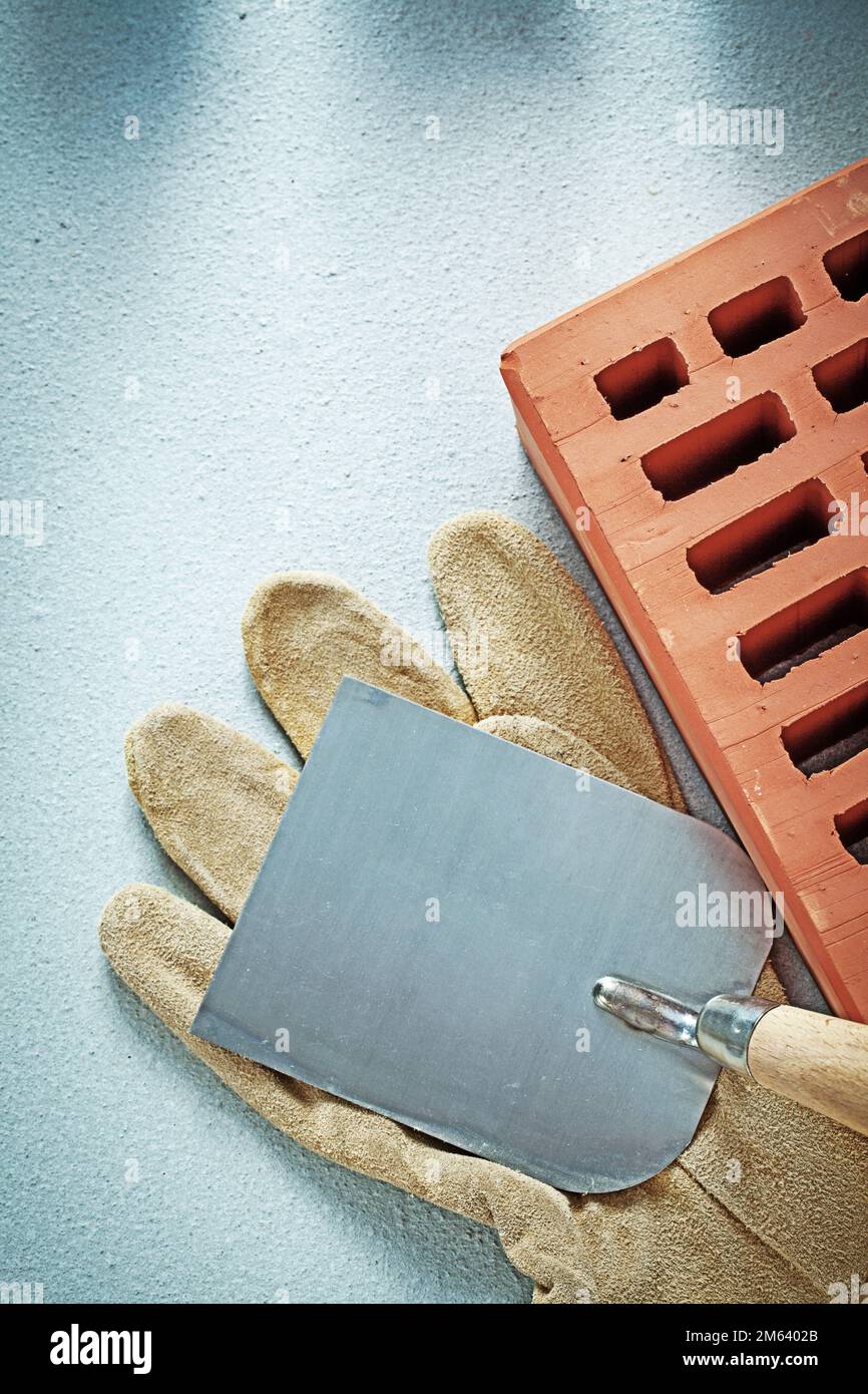 Construction brick safety gloves plastering trowel on concrete surface ...