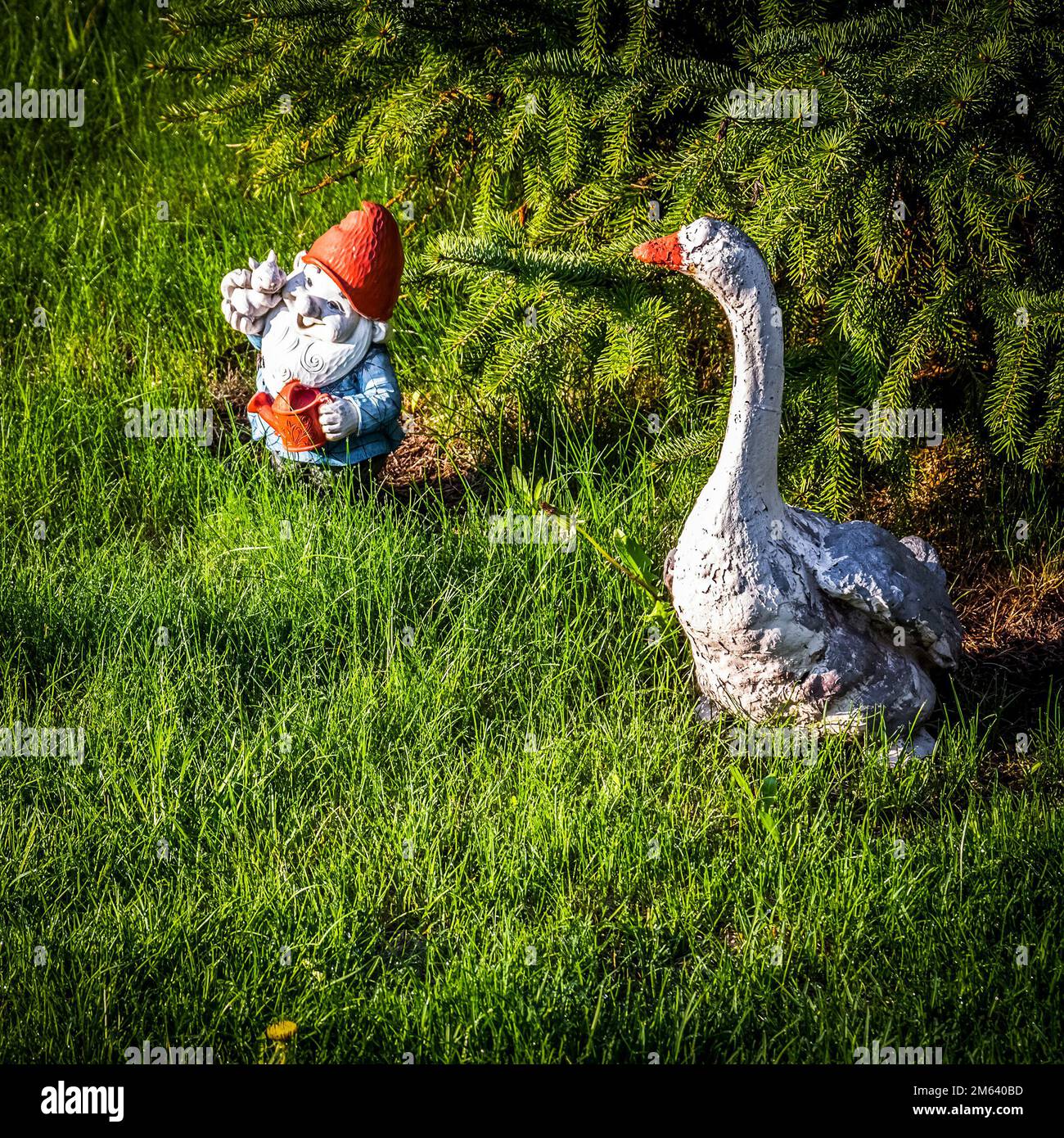 Old plaster garden figurines on the lawn in the backyard Stock Photo ...