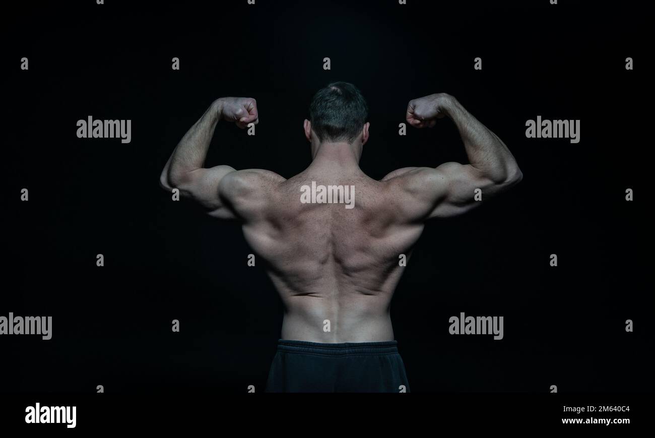 bodybuilder man muscular back in black studio. bodybuilder man muscular ...
