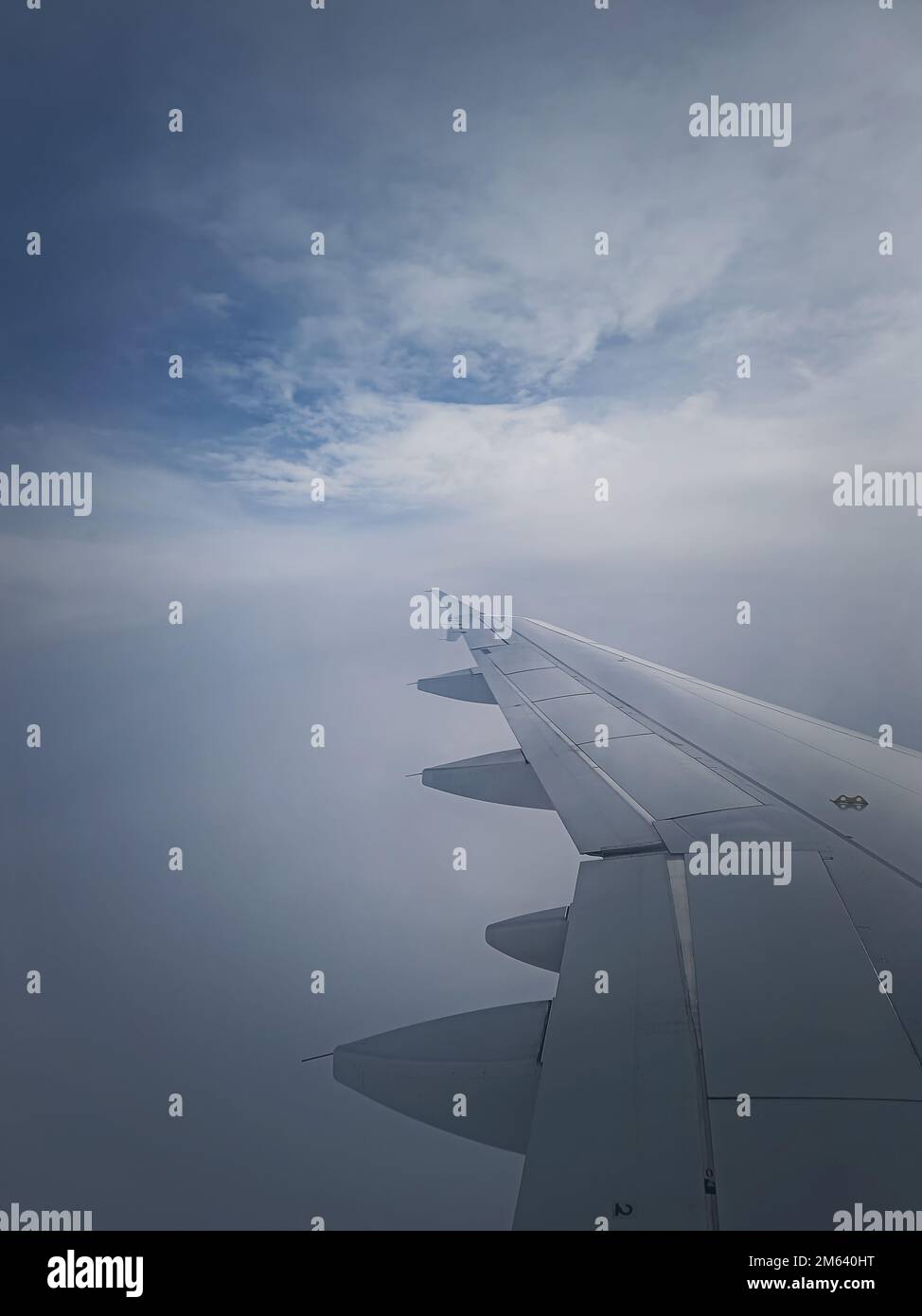 Plane flight through the dense foggy clouds, vertical shot. Airplane ...