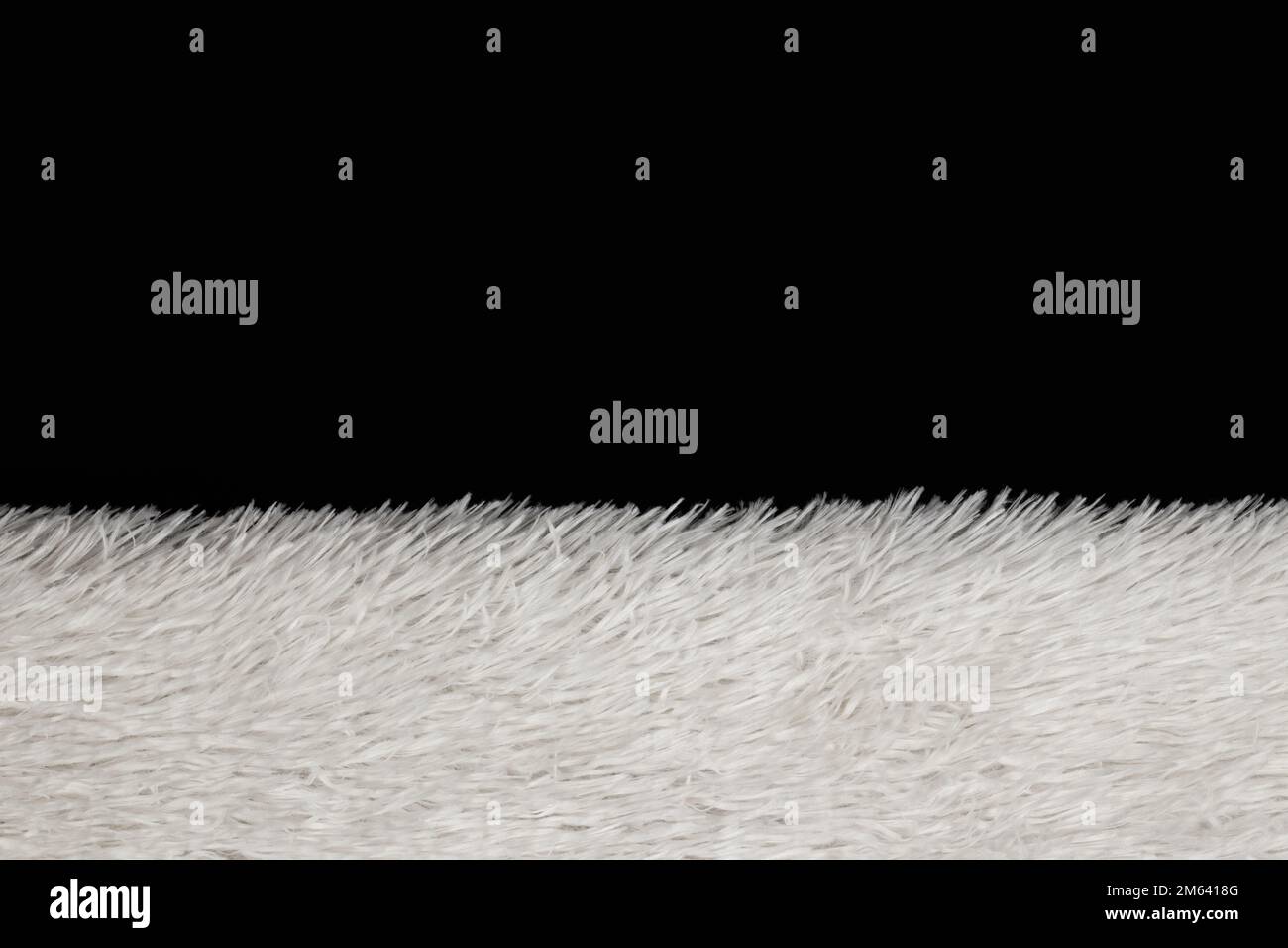 Synthetic fur white texture on black background Stock Photo - Alamy