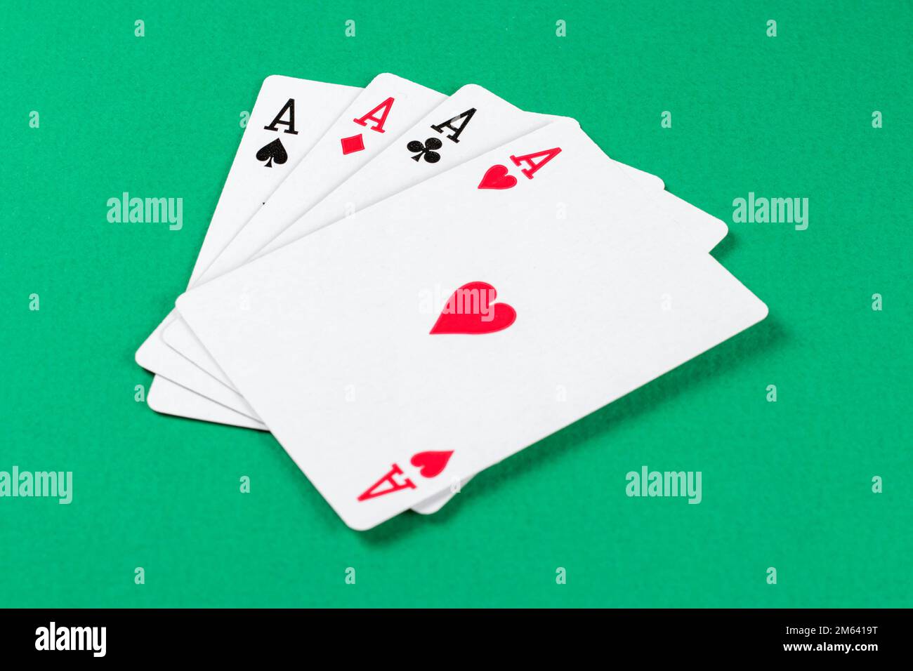 Playing cards on green background Stock Photo - Alamy