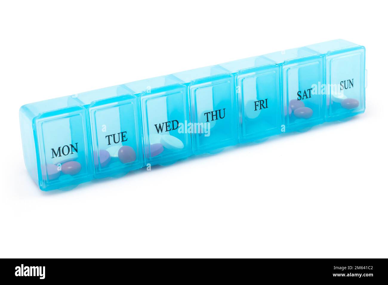 Pill organizer with variety of pills and supplement. a plastic weekly ...