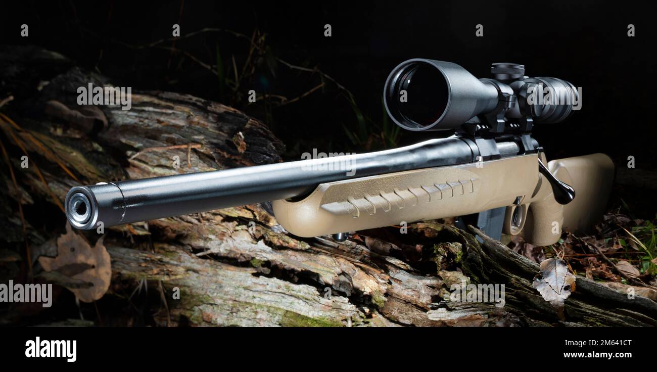 Scope on a bolt action hunting rifle in a dark forest Stock Photo - Alamy