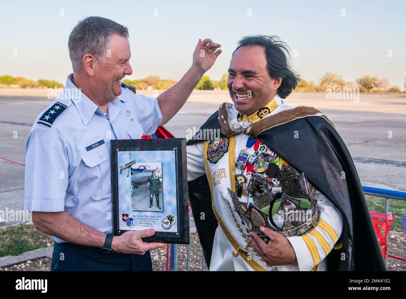 Lt. Gen. Brad Webb, commander of Air Education and Training Command, presents a framed photo to ...