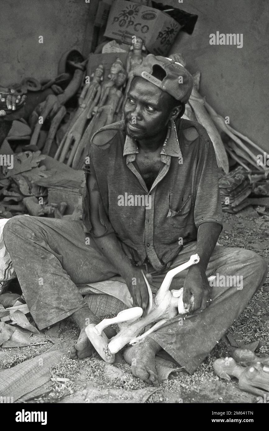 Kenyan carpenter carving wooden figurines Stock Photo - Alamy