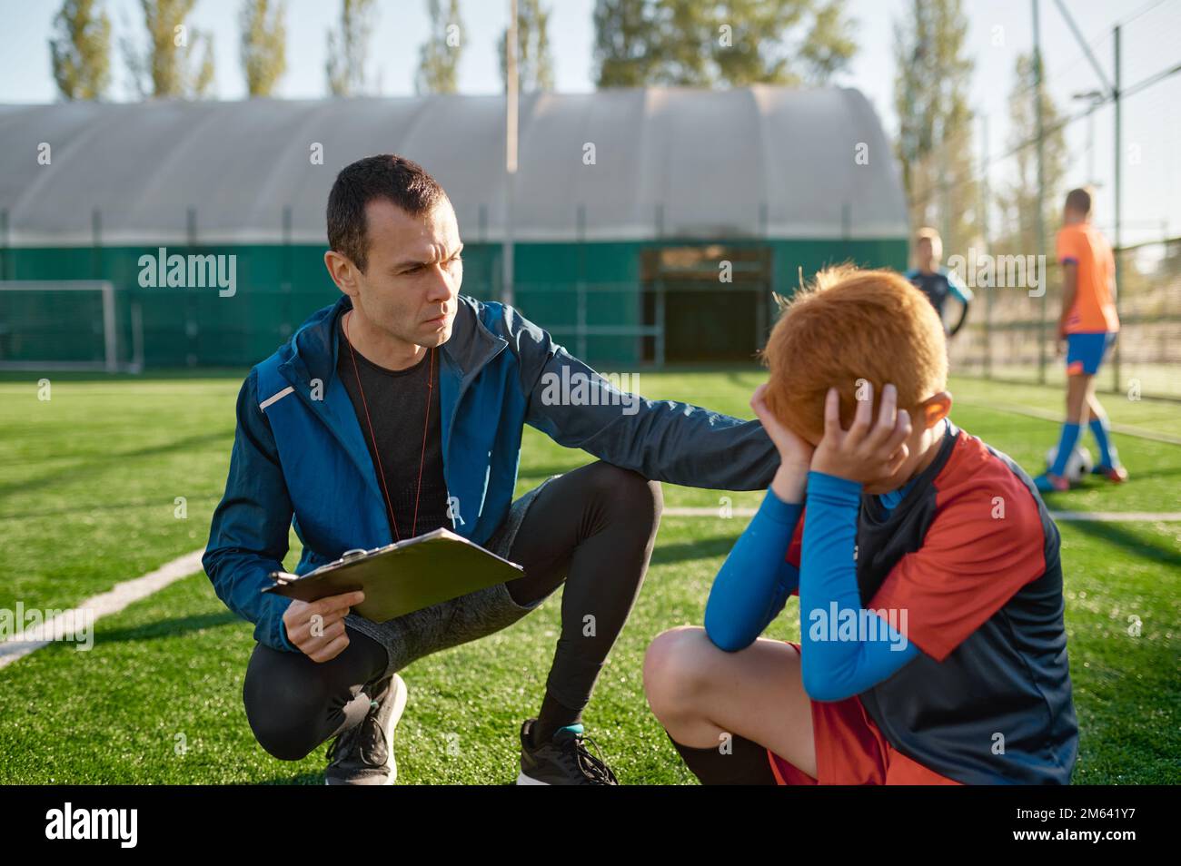 Coach comforting crying little soccer player after missed goal Stock ...