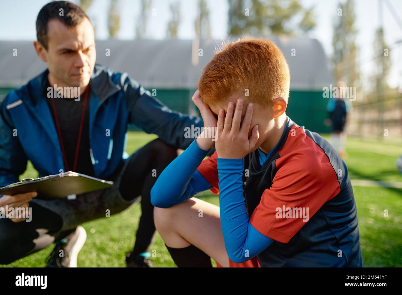 Coach comforting crying little soccer player after missed goal Stock ...