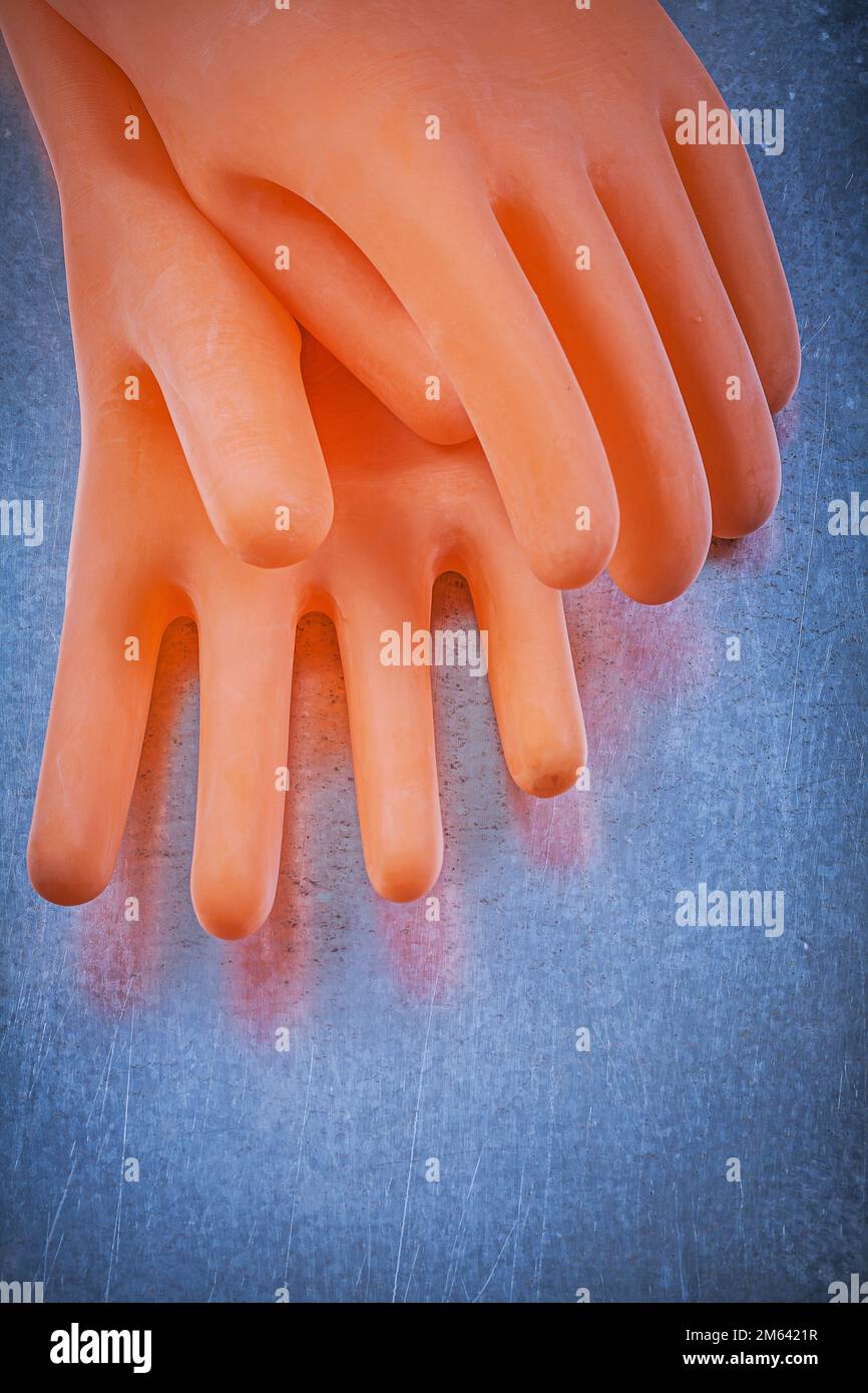 Dielectric rubber gloves on metallic background electricity concept ...