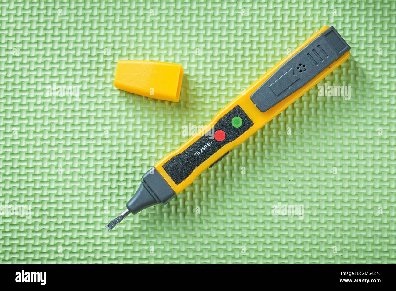 Electrical tester indicating device on green background electricity ...