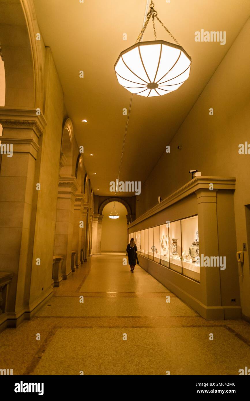 Single woman walking down a corridor in the Metropolitan Museum of Art ...
