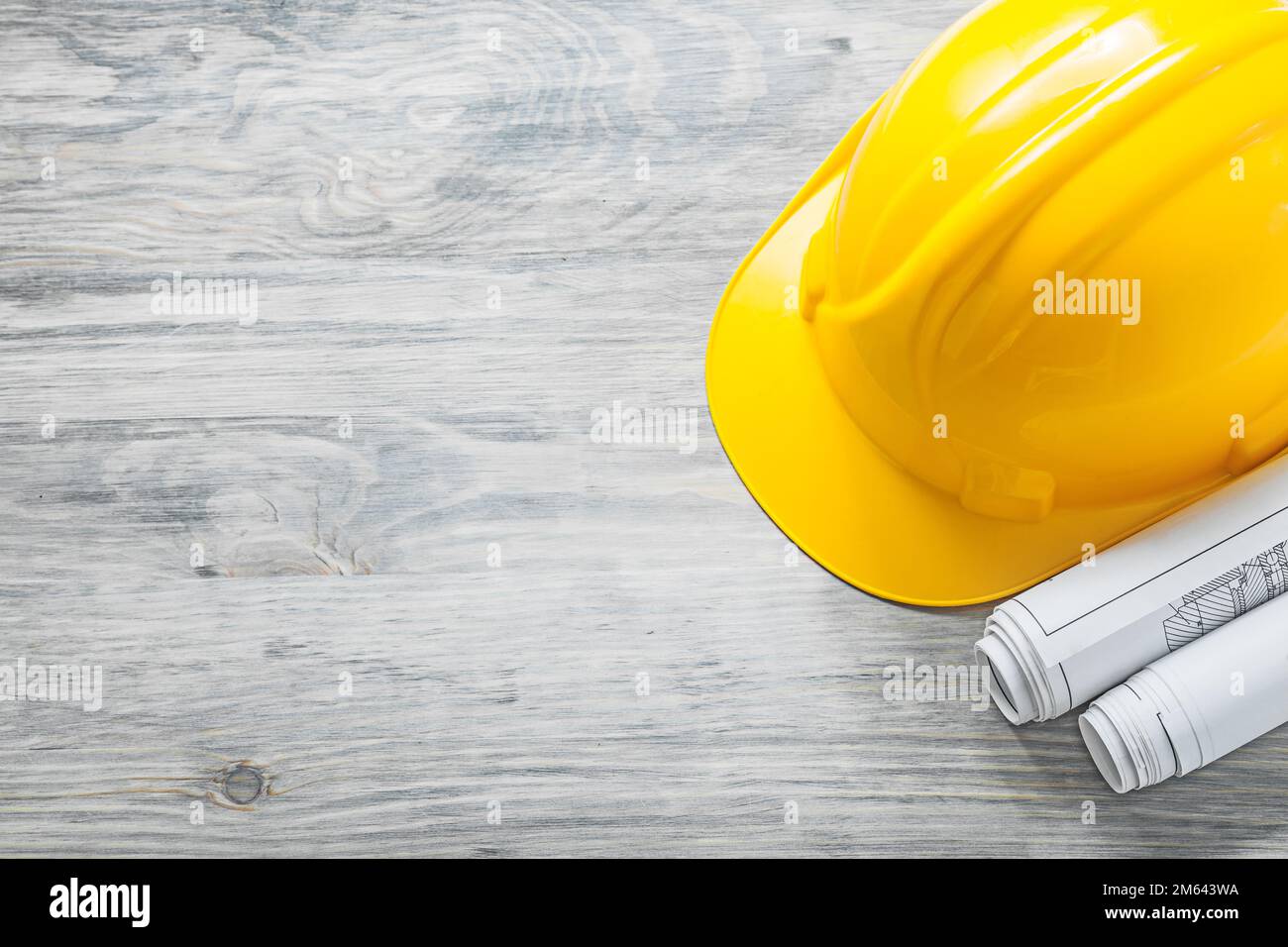 Hard hat construction plans on wooden board building concept Stock ...