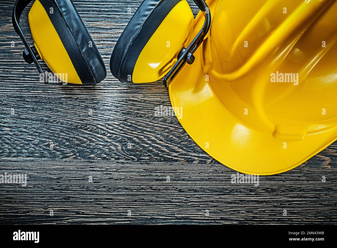 Hard hat earmuffs on wooden board Stock Photo - Alamy