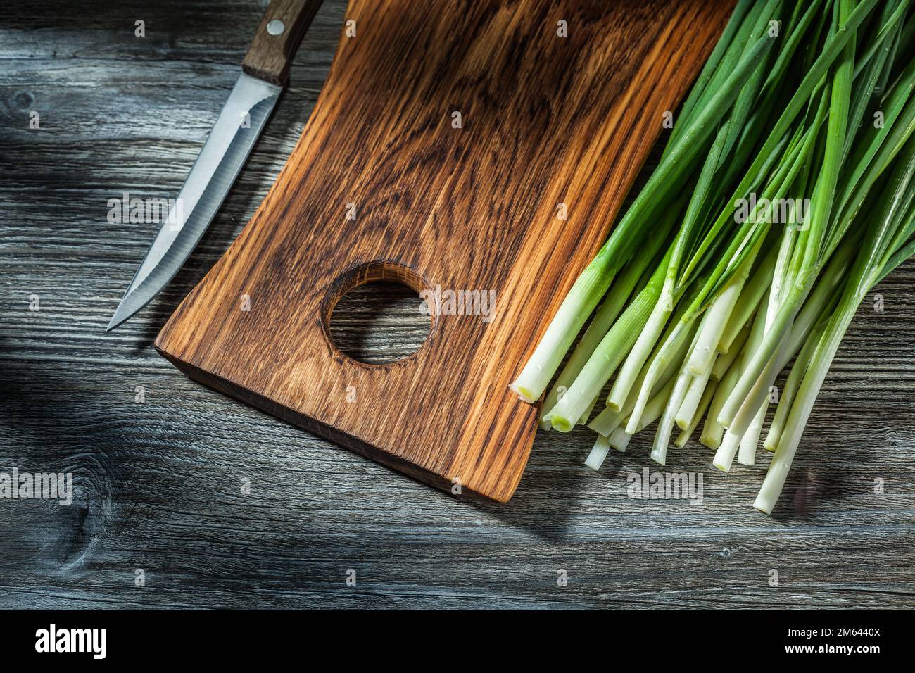kitchen knife wooden chopping board fresh spring green onion stems on ...
