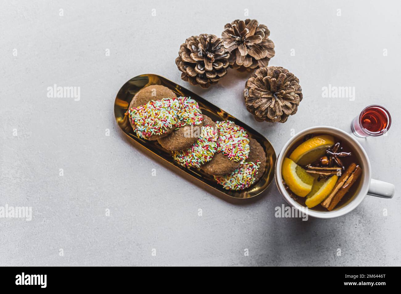 Sugar cookies covered halfway with colorful sprinkles standing next to ...