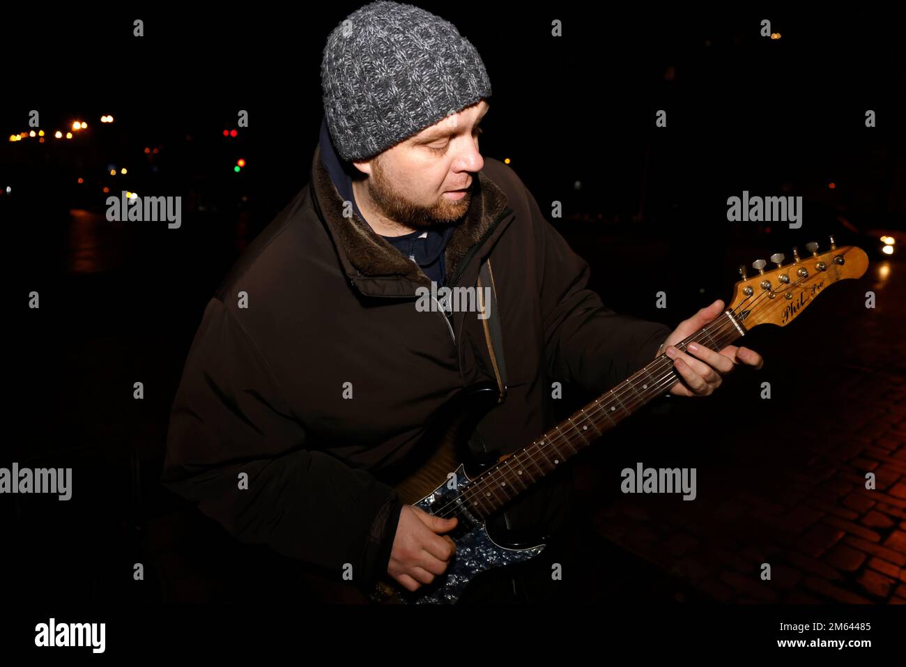 KYIV, UKRAINE - DECEMBER 31, 2022 - A man plays the electric guitar ...