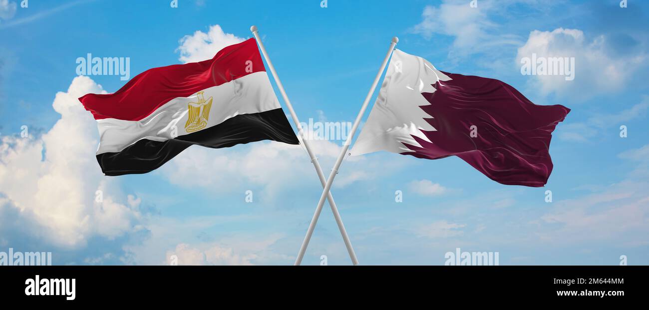 two crossed flags Qatar and Egypt waving in wind at cloudy sky. Concept of relationship, dialog ...