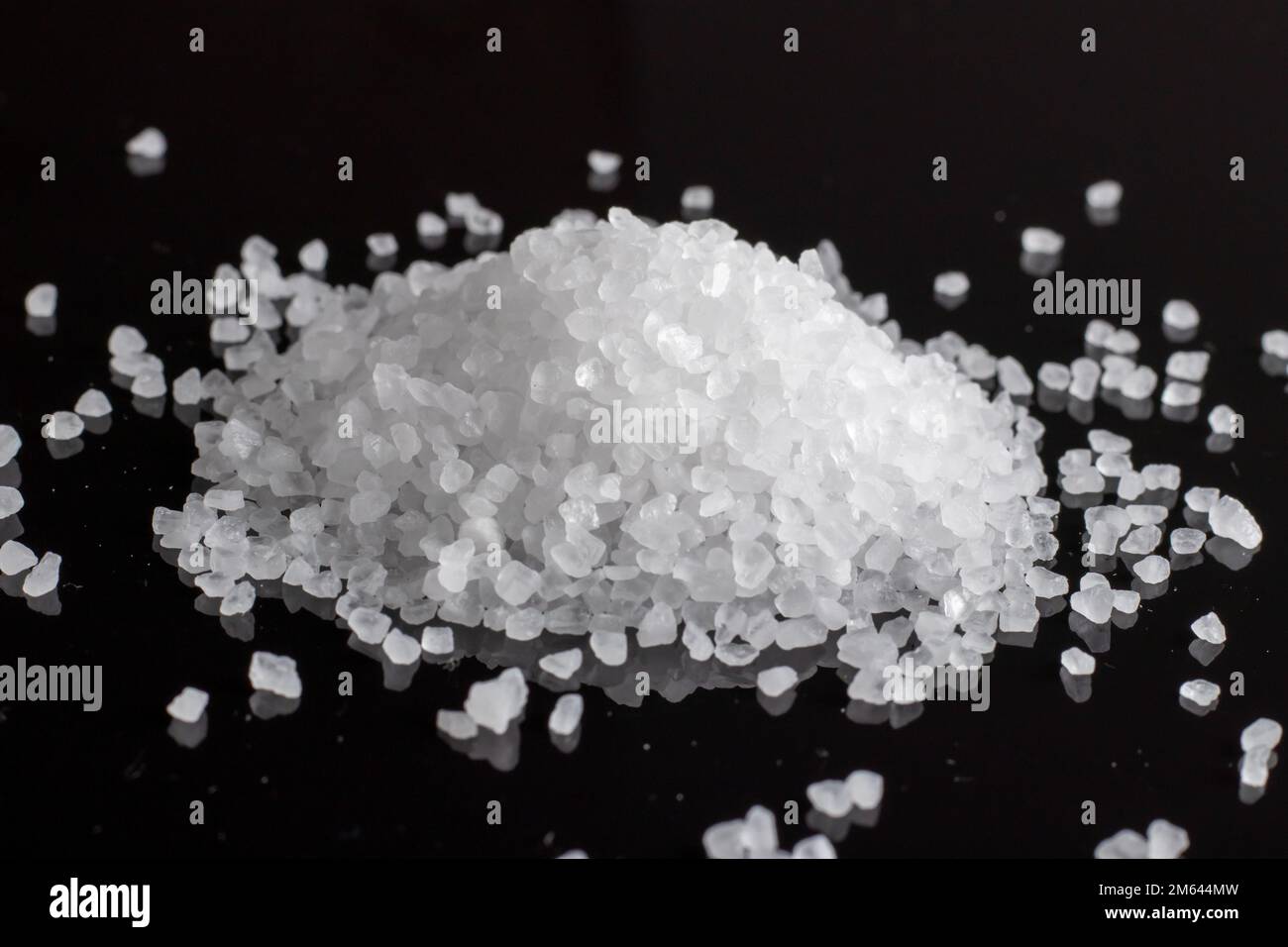 Heap crystals of sea salt or coarse salt on black background Stock ...