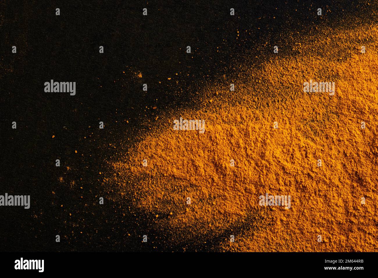 Yellow color powder explosion on black background Stock Photo - Alamy