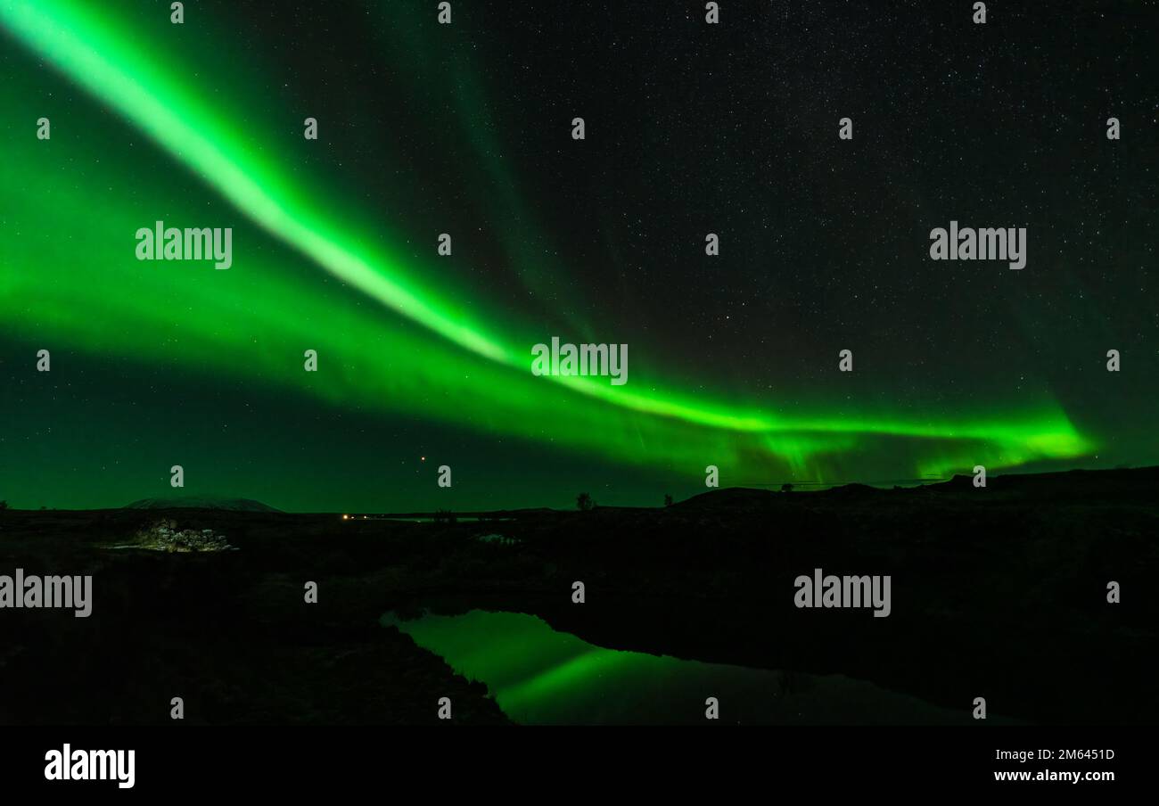 Northern lights green beam over the river Stock Photo - Alamy