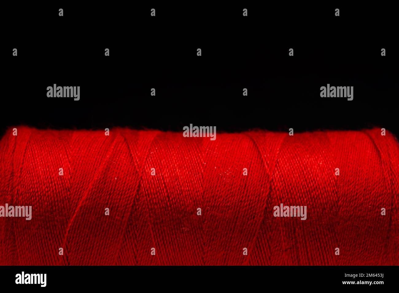 Red thread passing through needles on a black background Stock Photo ...