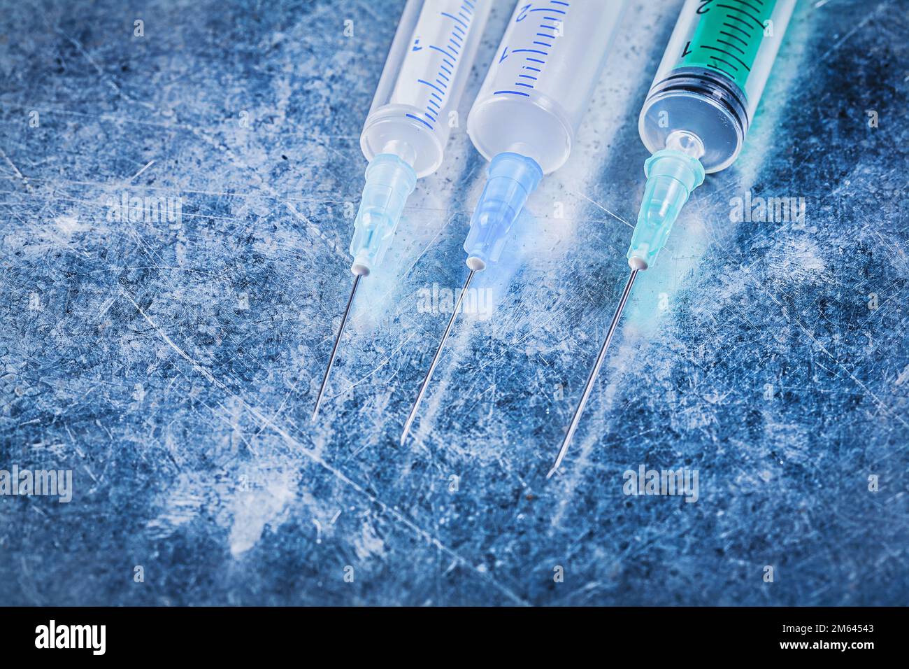 Medical single-use needle injectors on metallic background medicine ...