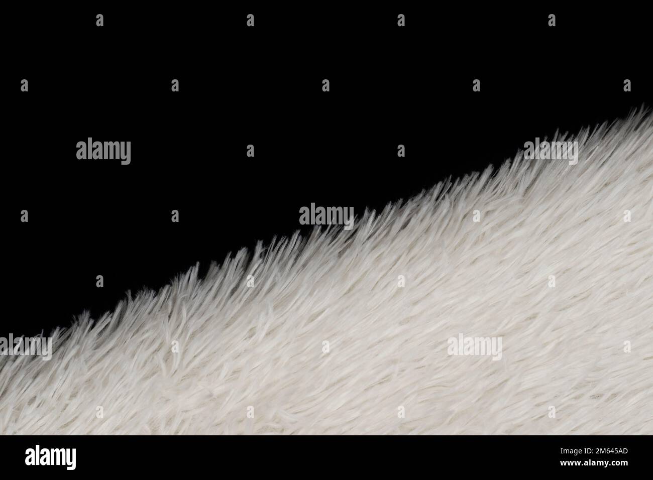 Synthetic fur white texture on black background Stock Photo - Alamy