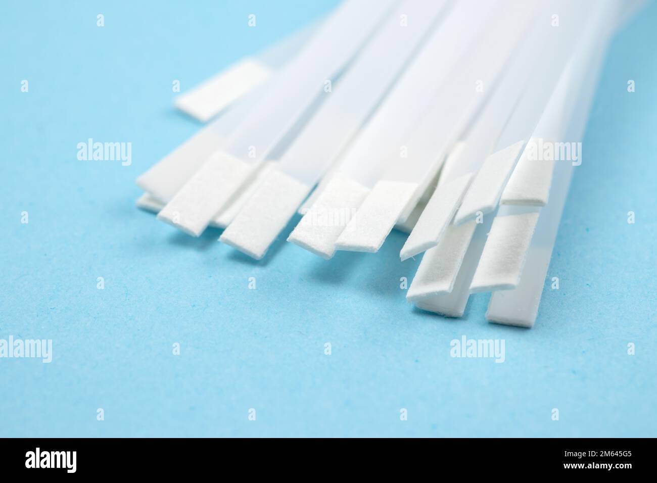 Test strip for acetone on blue background Stock Photo - Alamy