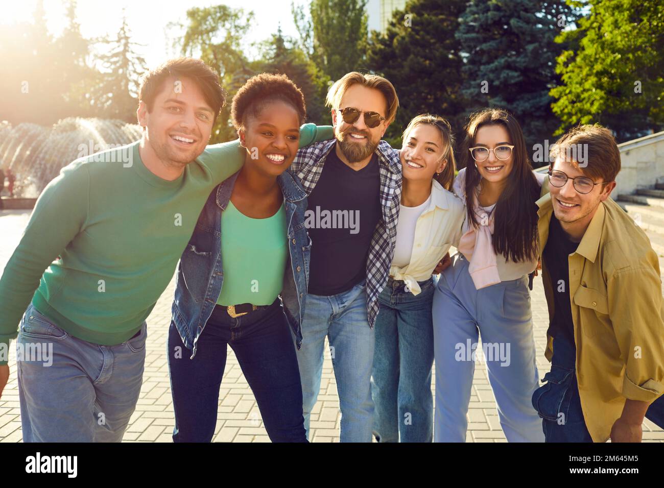 Group Of Happy Cheerful Young Multiethnic Friends Hugging And Having