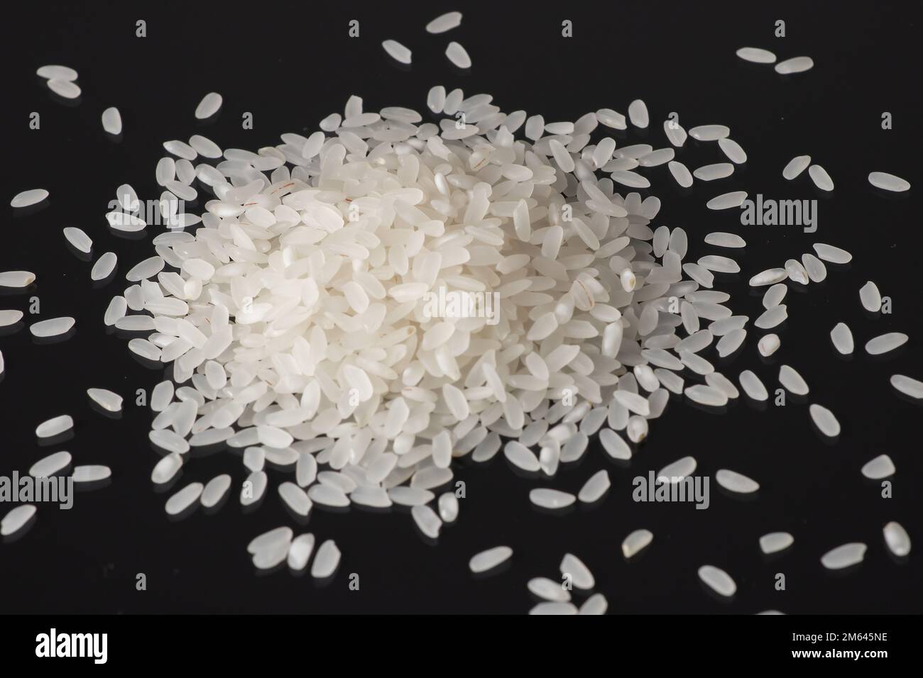 Pile white rice on black background. close up Stock Photo - Alamy