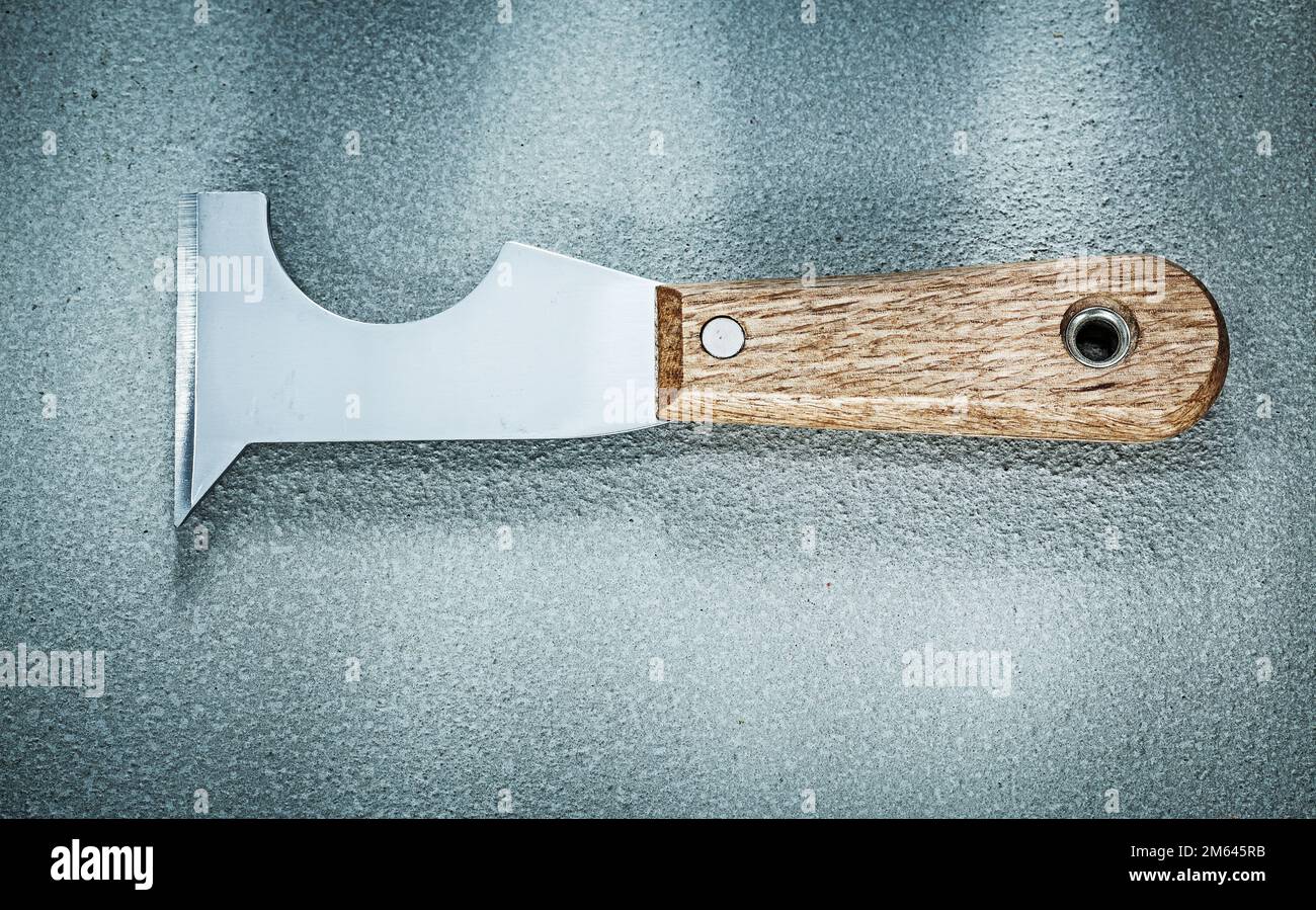 Putty knife on concrete surface directly above construction concept ...