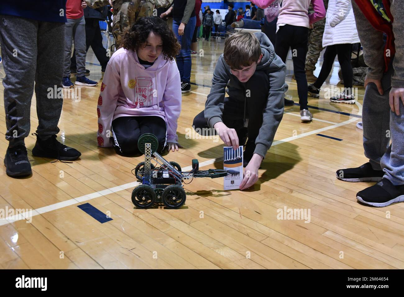 Students from Altus Junior High School play with a robot provided by ...