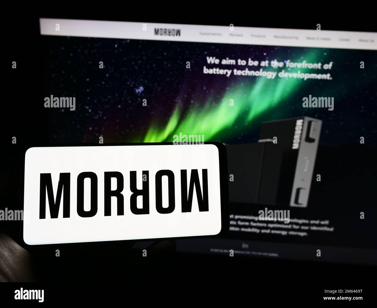 Person holding cellphone with logo of Norwegian battery company Morrow ...