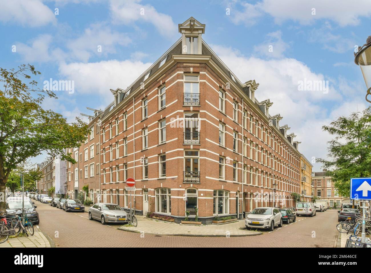 a street with cars parked on the side and buildings in the middle part ...