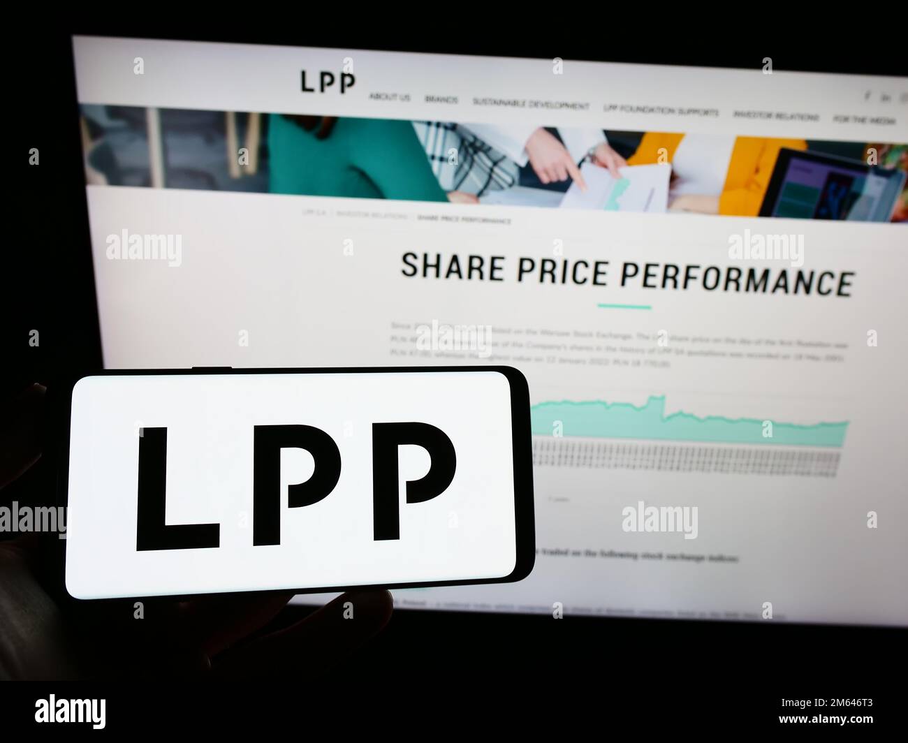 Person holding mobile phone with logo of Polish clothing retail company ...