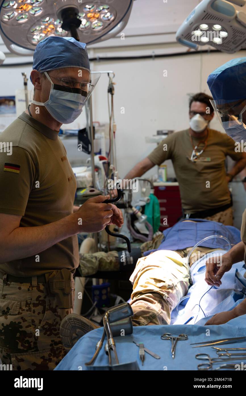 A German Surgical Team, prepares equipment and a patient for a ...