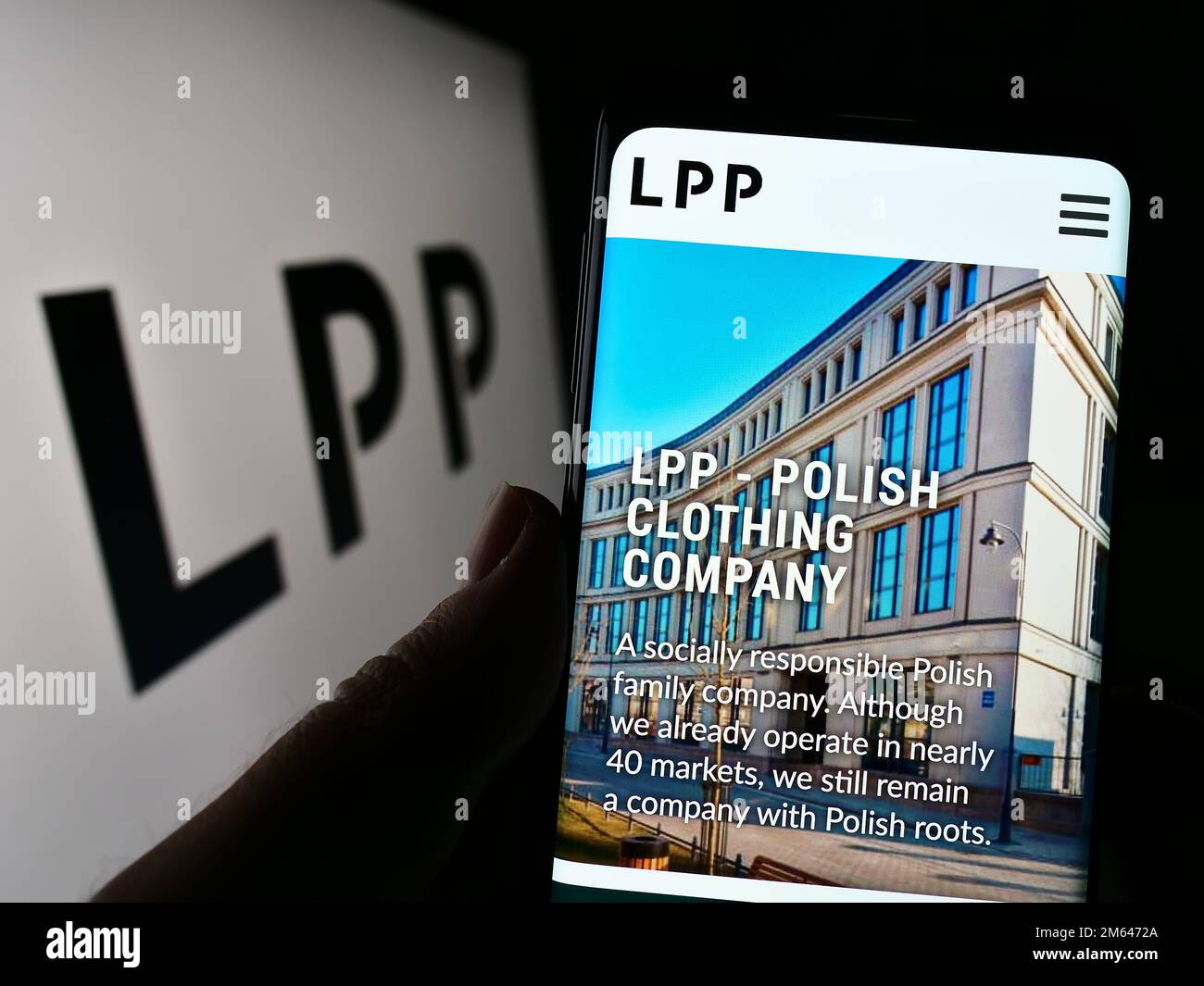 Person holding smartphone with website of Polish clothing retail ...