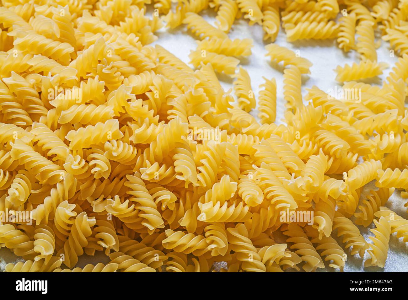 Stack of spiral macaroni on blue background food and drink concept ...