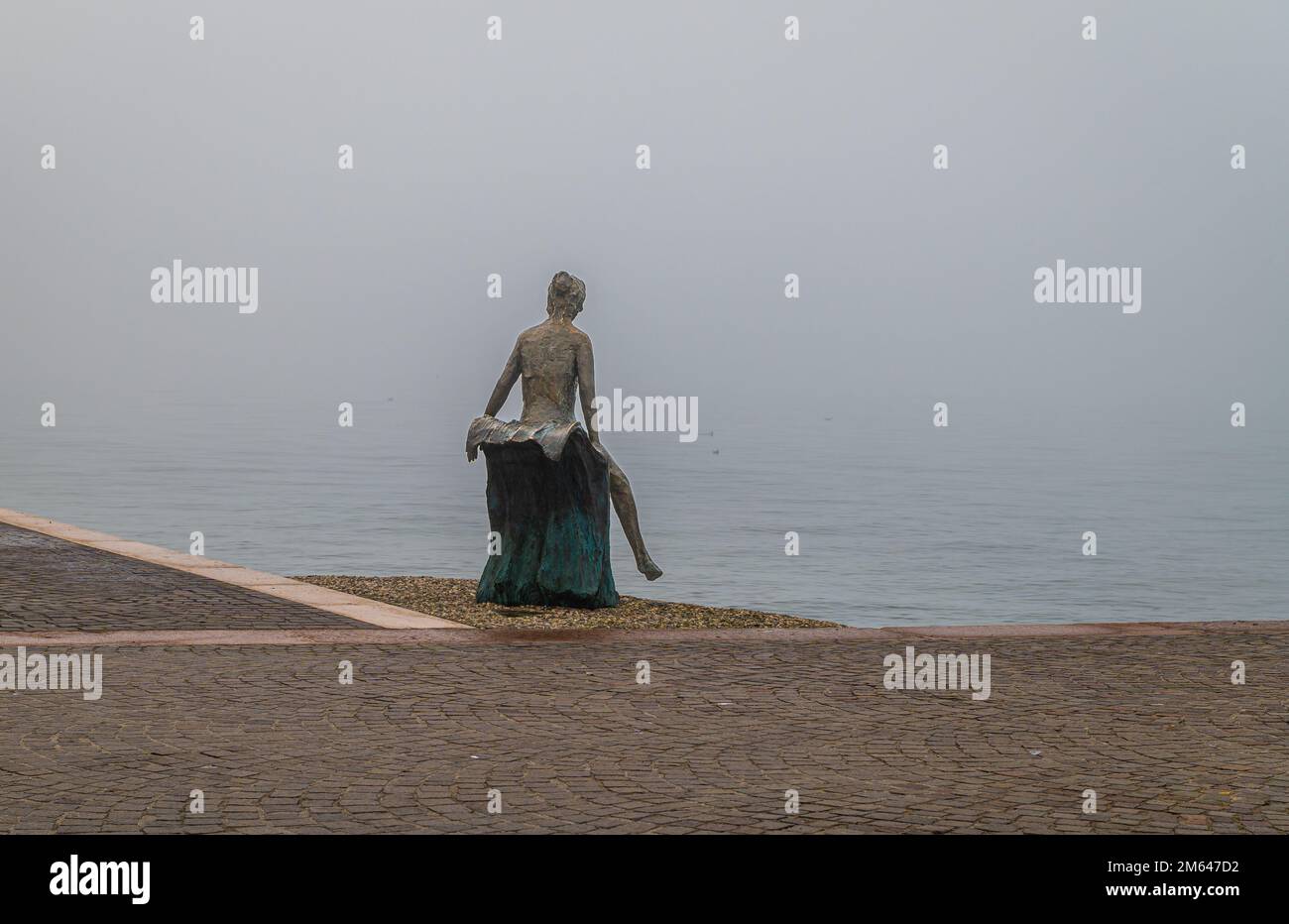 Statue of the Little Mermaid of the picturesque town of Lazise on Lake ...