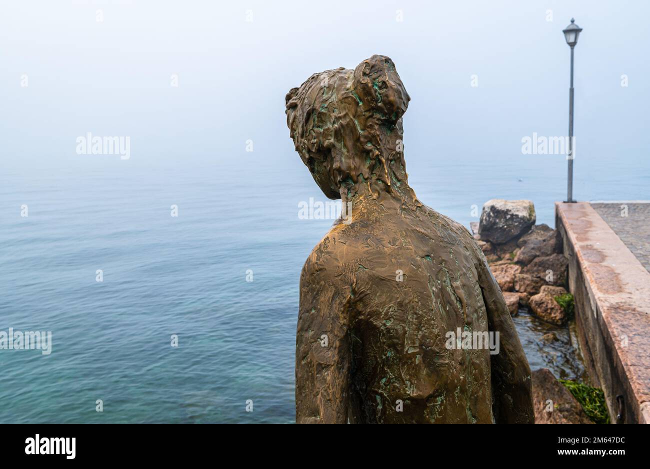 Statue of the Little Mermaid of the picturesque town of Lazise on Lake ...