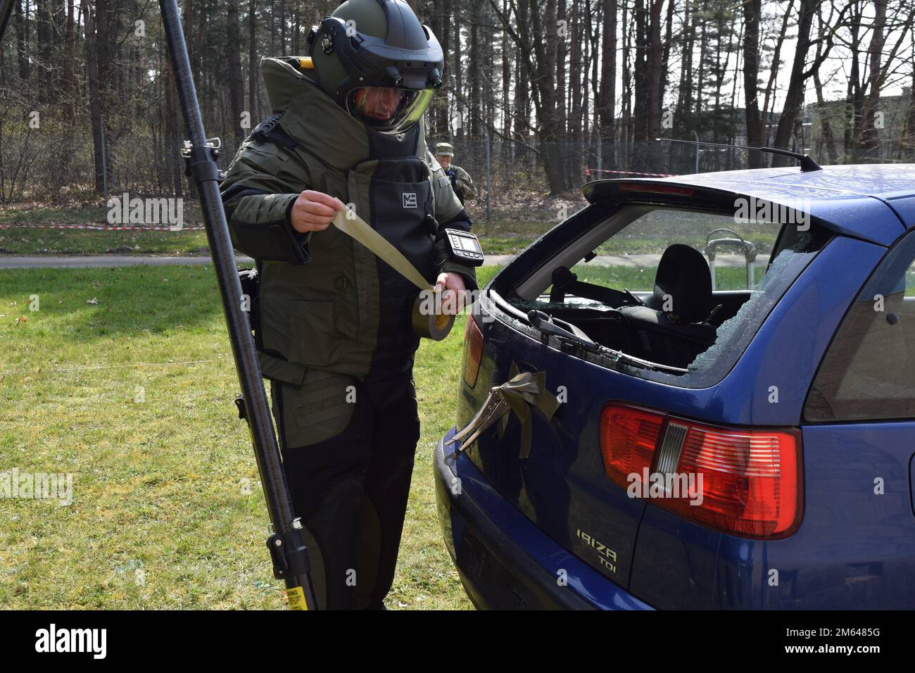 A member of the Belgian explosive ordnance disposal unit works on a car ...