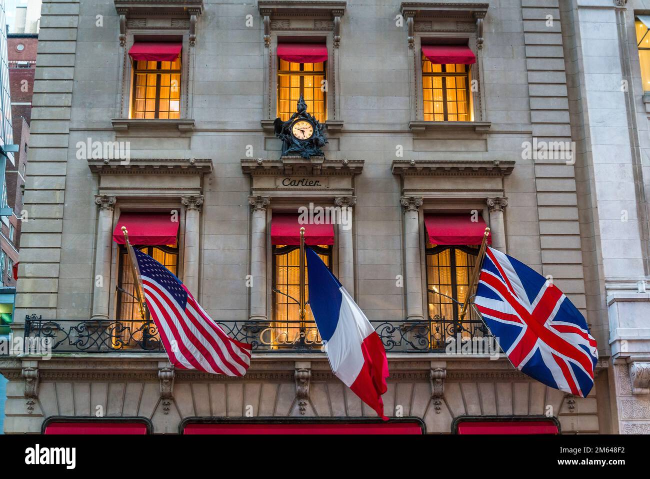 American, French and British flags on a building in the 5th avenue, New ...