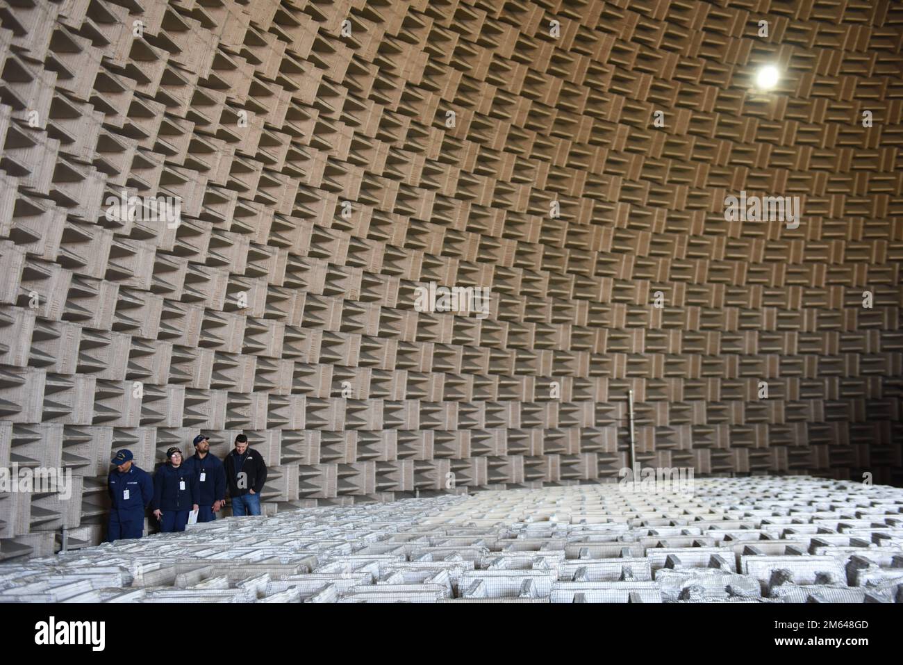 U.S. Coast Guardsmen walk with a member of NASA around the Aeroacoustic ...